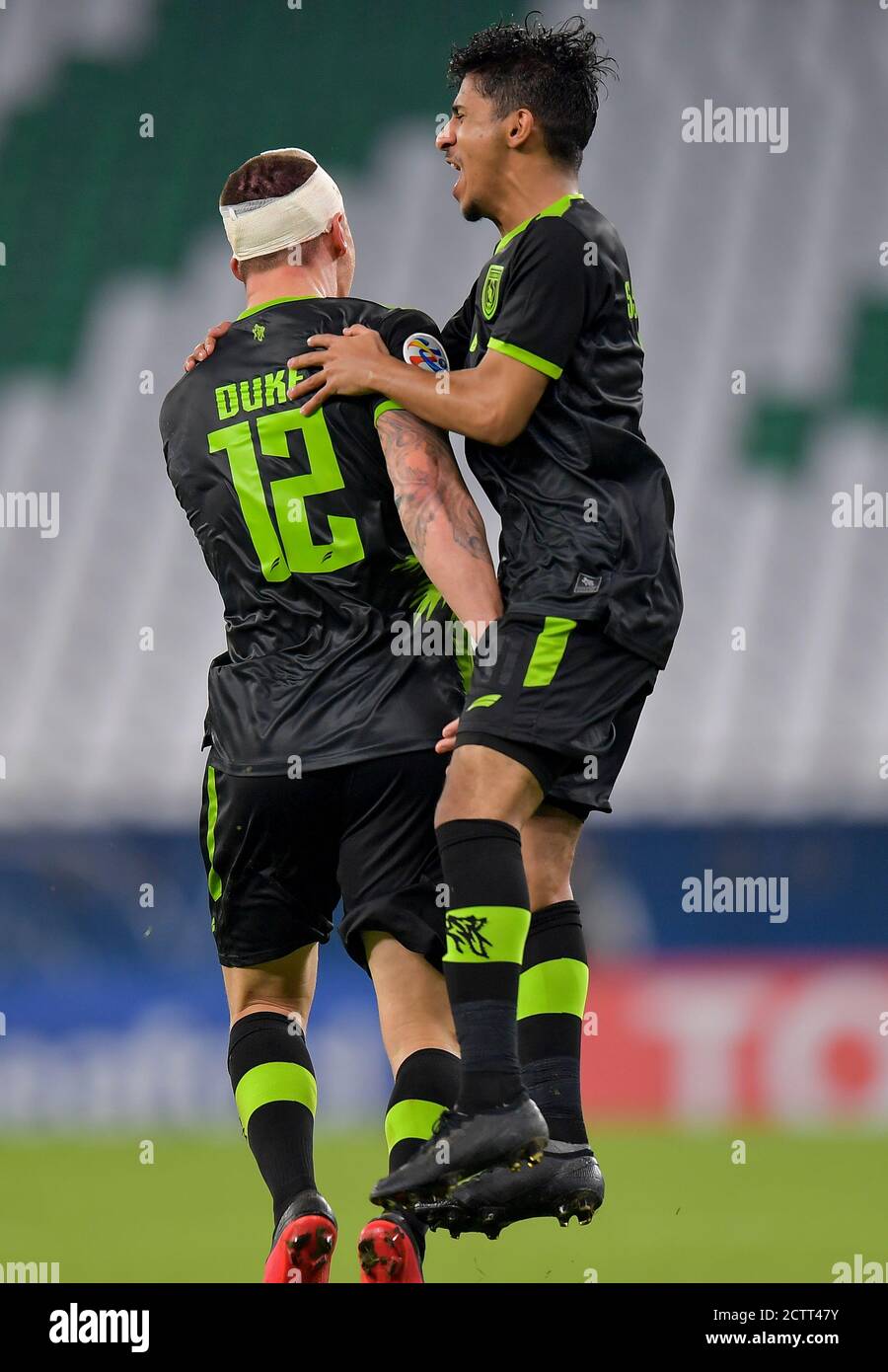 Doha, Qatar. 24th Sep, 2020. Mitchell Duke (L) of Taawoun FC celebrates ...