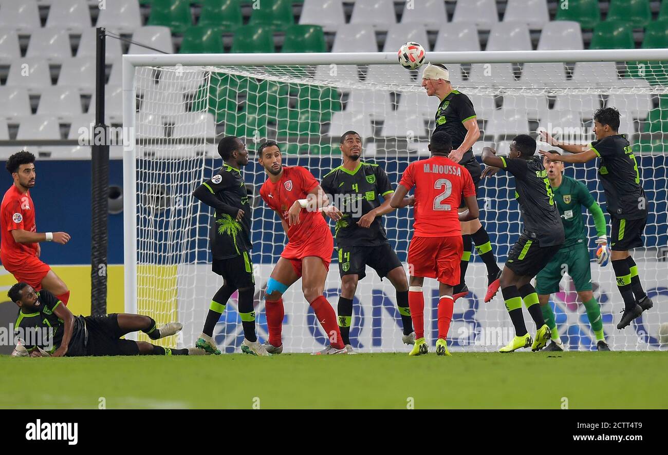 Doha, Qatar. 24th Sep, 2020. Mitchell Duke (top) of Taawoun FC heads ...