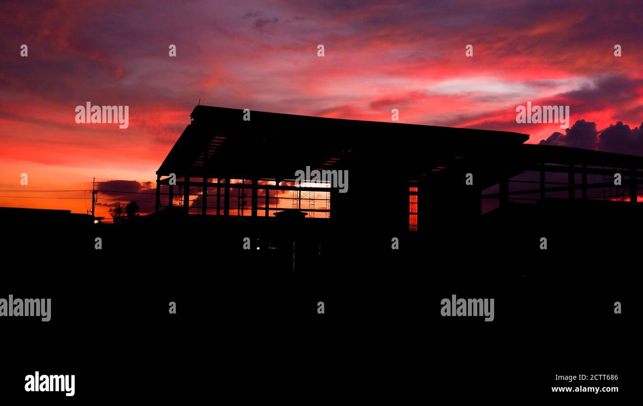Sunset sky gradient with trees and warehouse silhouette Stock Photo - Alamy