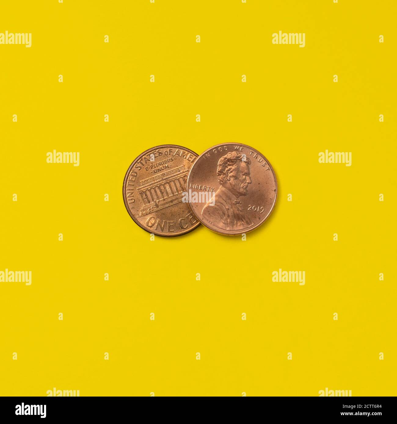 Front and back of two pennies on yellow background Stock Photo - Alamy
