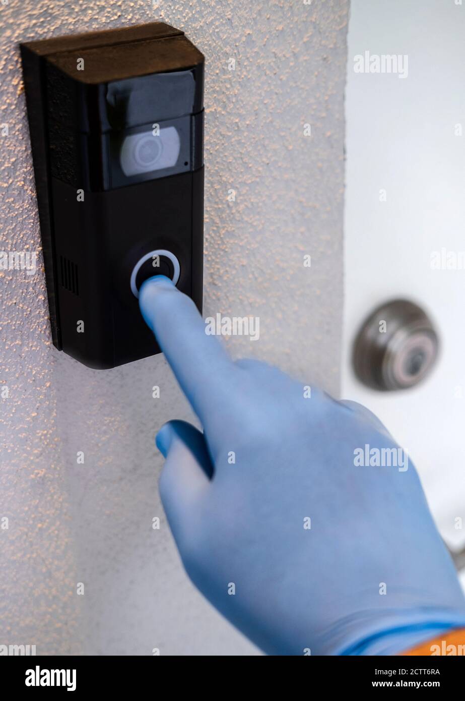 Hand with surgical on door bell Stock Photo - Alamy