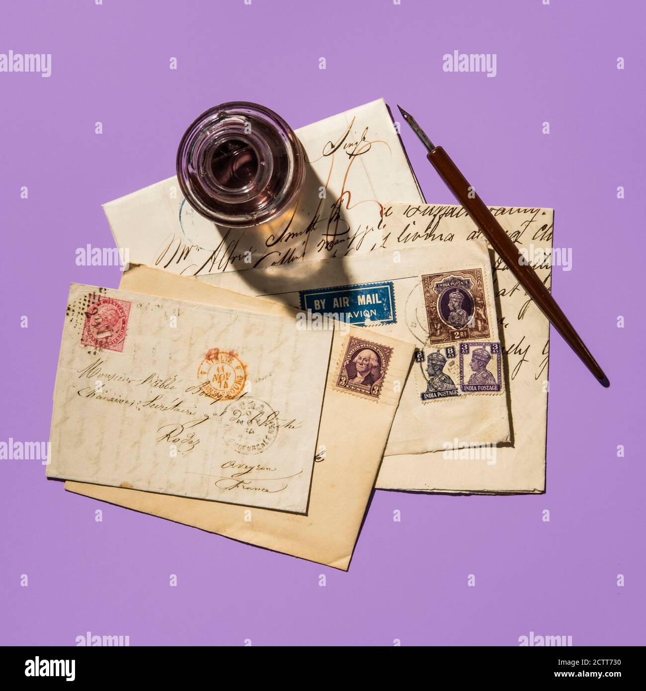 Antique ink well and old letters on purple background Stock Photo - Alamy