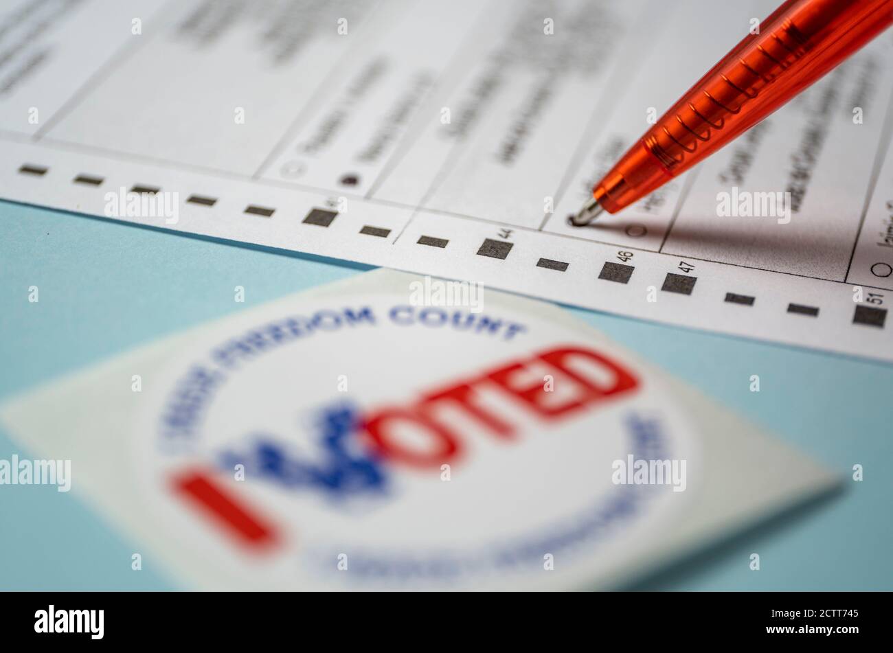 Voting form with pen and badge on blue background Stock Photo - Alamy