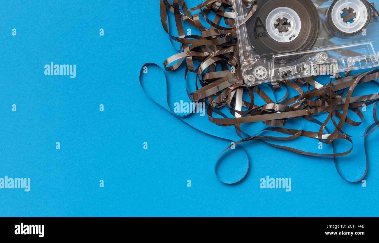Analog audio cassette on blue background Stock Photo - Alamy