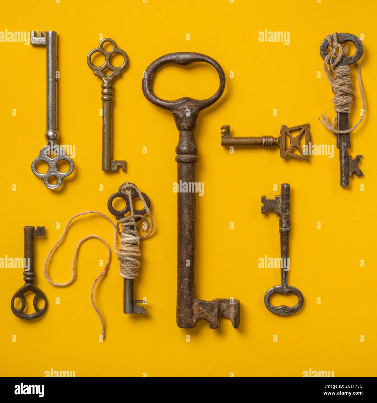 Antique keys on yellow background Stock Photo - Alamy
