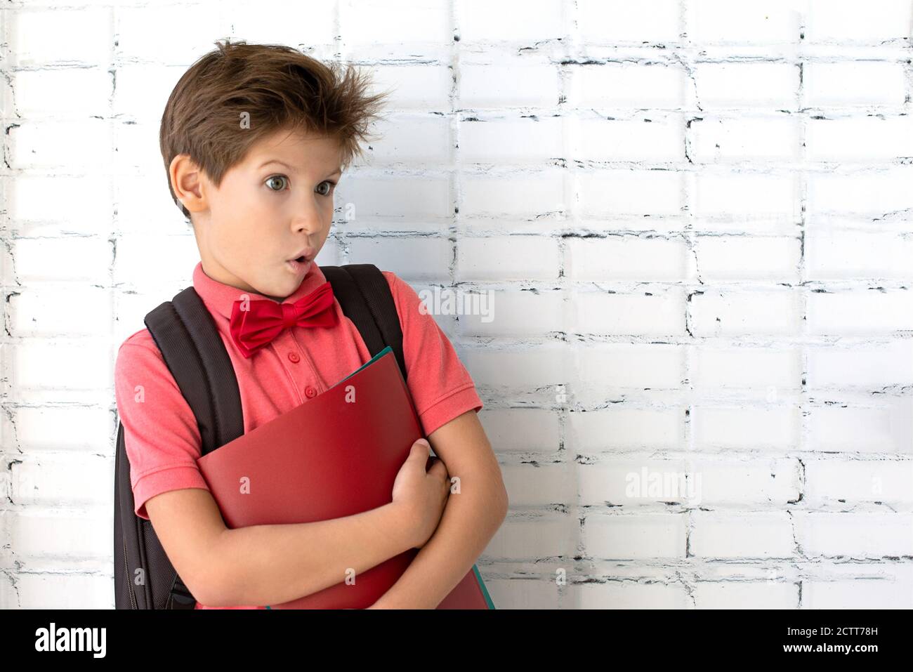Back to school.. Schoolboy with a surprised face with copy space. Pupil ...