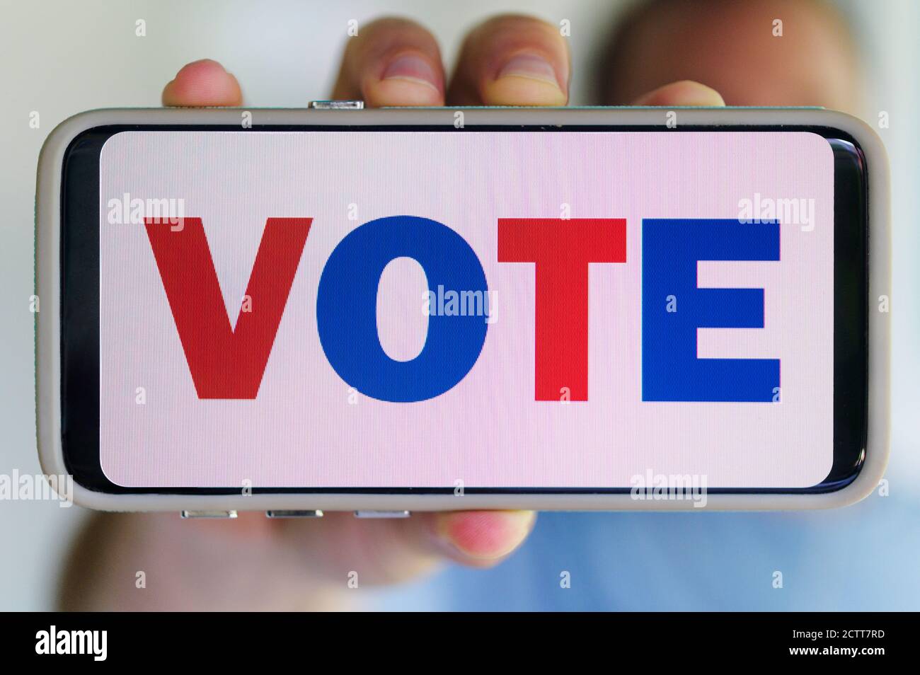Hand holding smartphone with voting message Stock Photo - Alamy