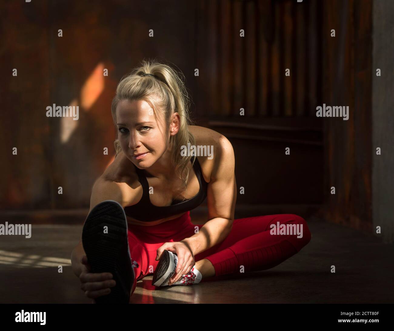 Woman stretching indoors gym on hi-res stock photography and images - Alamy