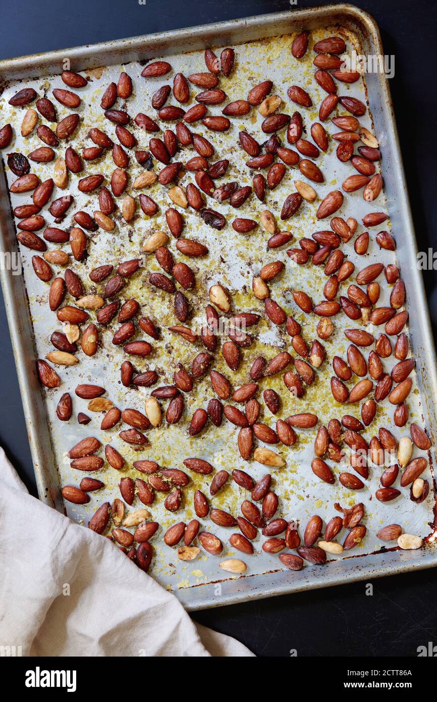 Roasted almonds on baking sheet Stock Photo - Alamy