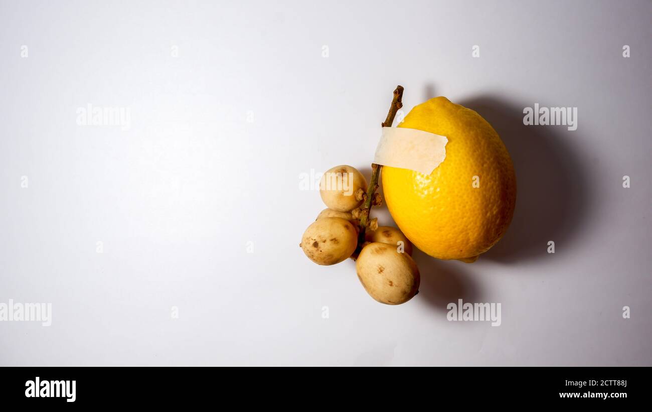 Two contrasting fruits taped together Stock Photo - Alamy