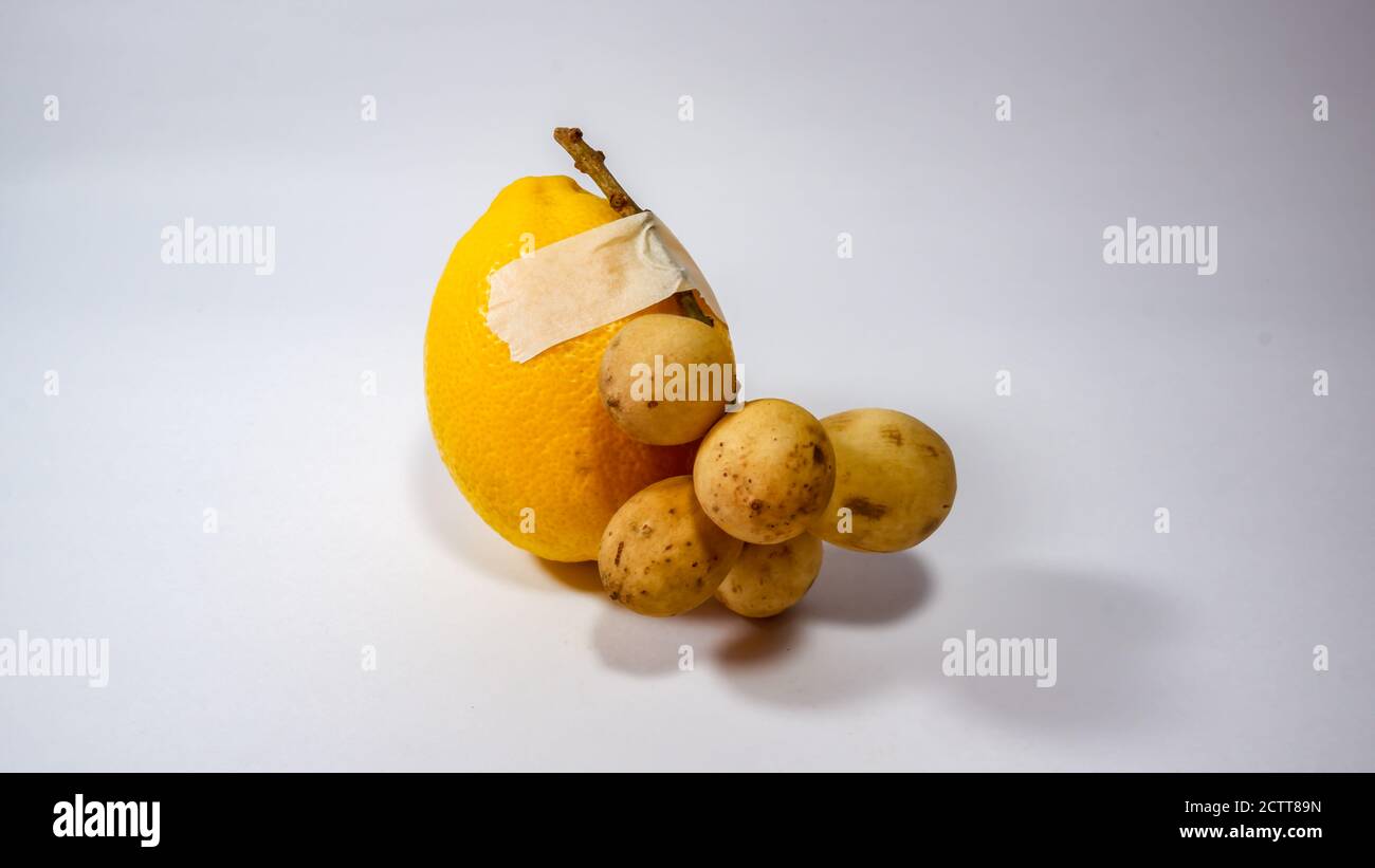 Two contrasting fruits taped together Stock Photo - Alamy