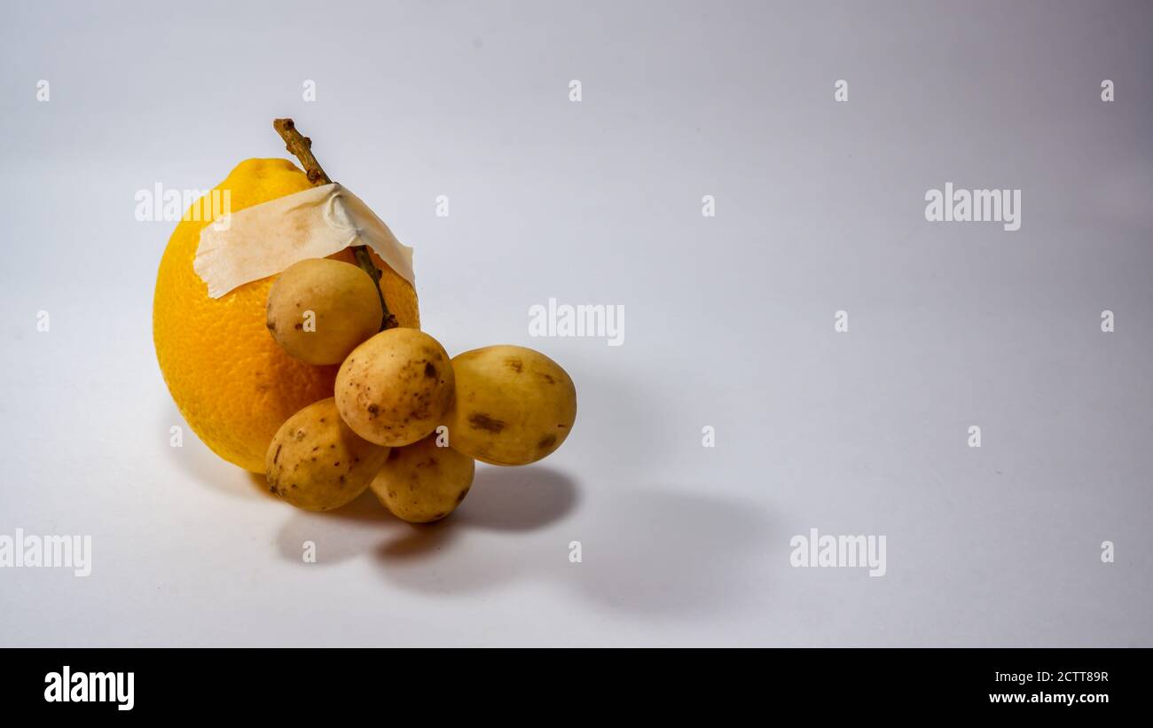 Two contrasting fruits taped together Stock Photo - Alamy