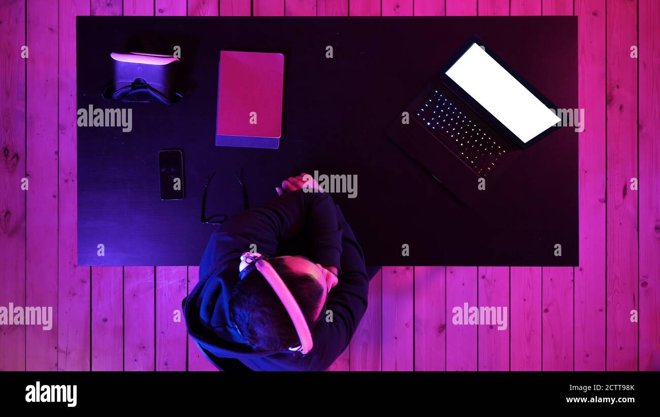 Gamer wearing headset watching stream of a game. White Display Stock ...