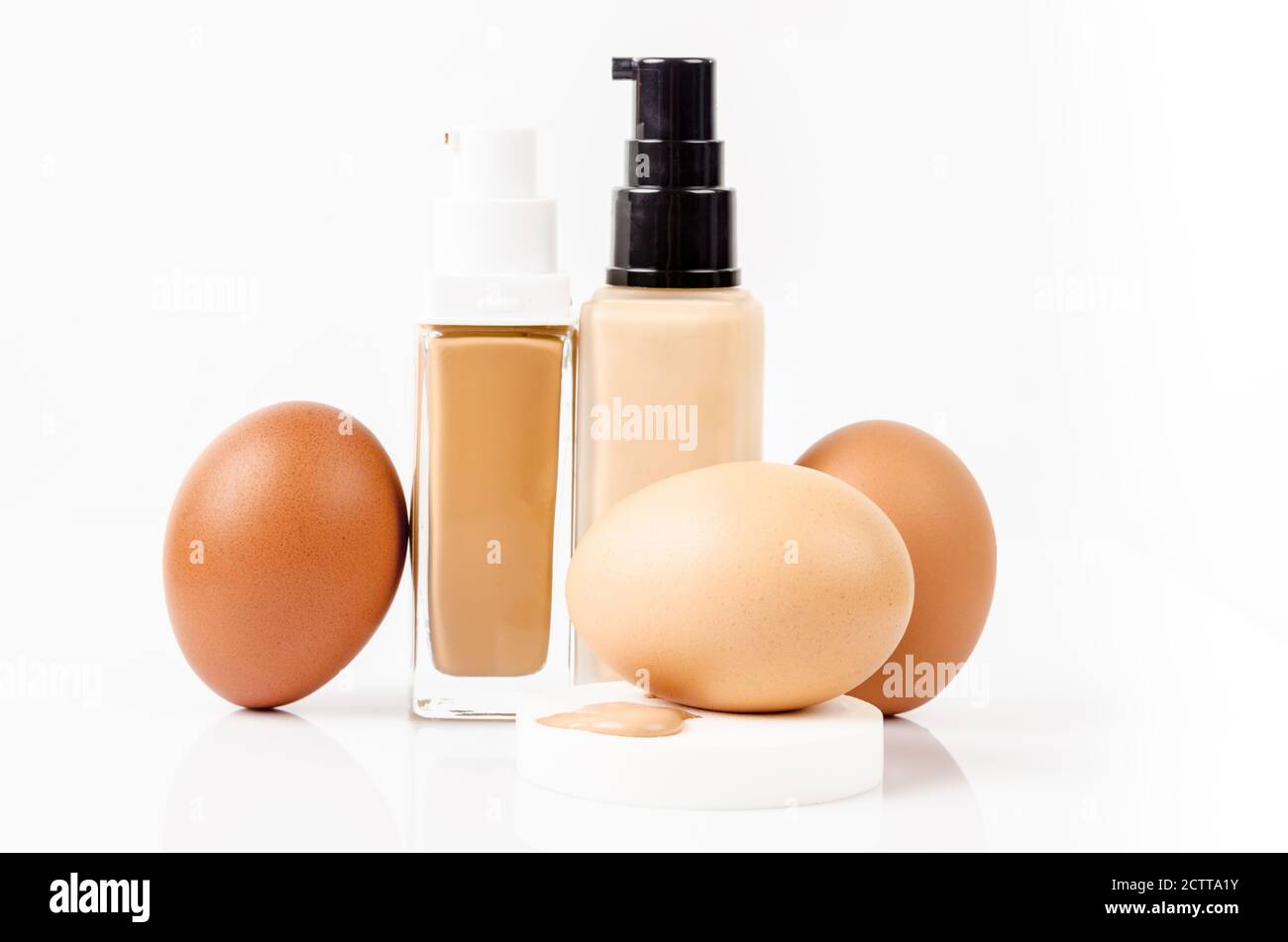 Liquid fluid foundation glass bottle and eggs isolated on white ...