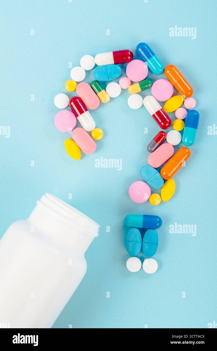 A question mark from laid out of medicine pills with bottle drug on ...