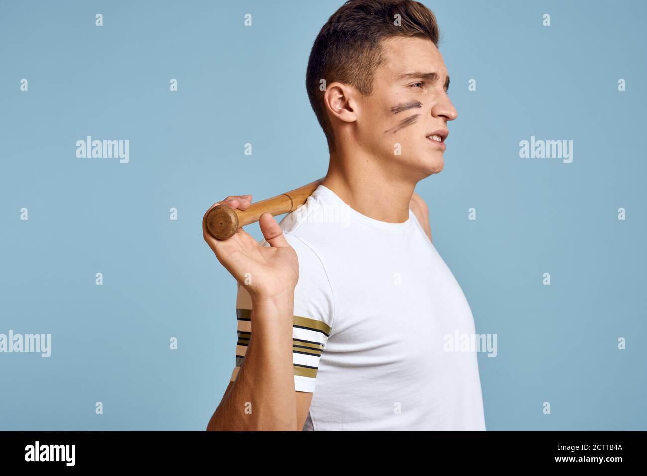 baseball guy with a bat in his hand on a blue background and a combat ...