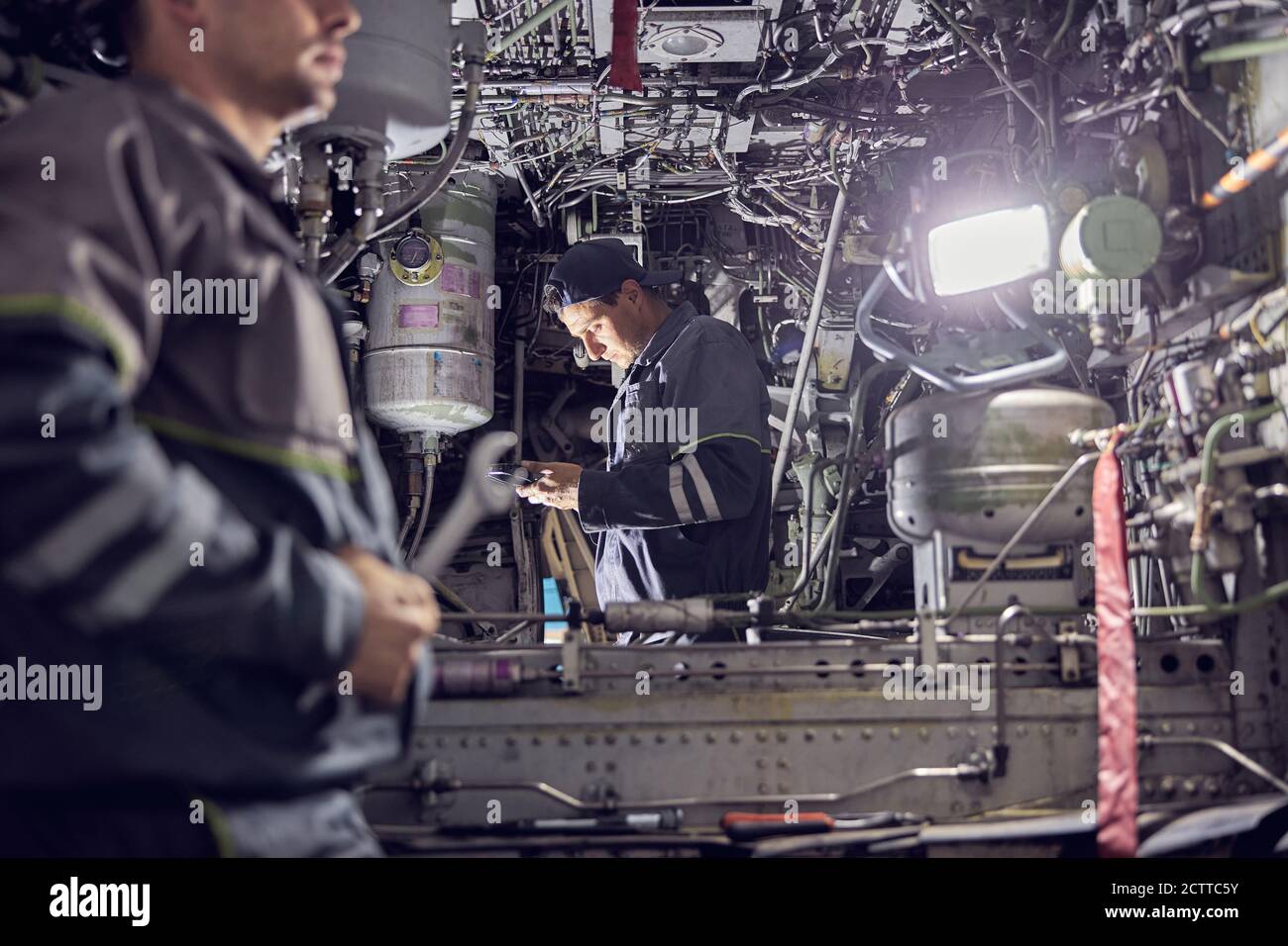 Ground crew working with airplane system at the airport Stock Photo - Alamy