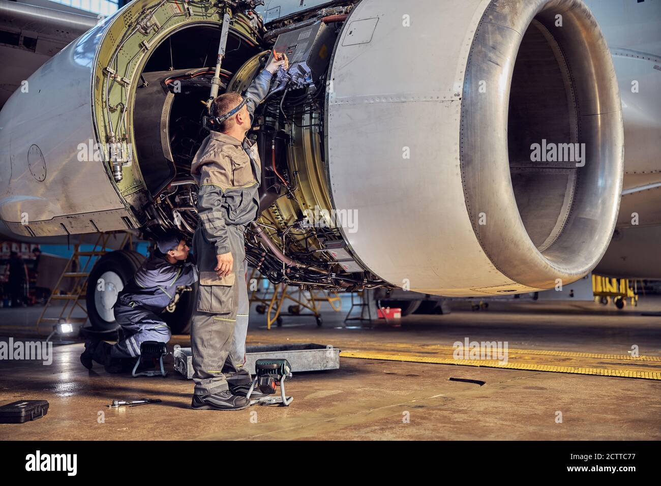 View of airplane and engine mechanisms on the wing in the indoors Stock ...