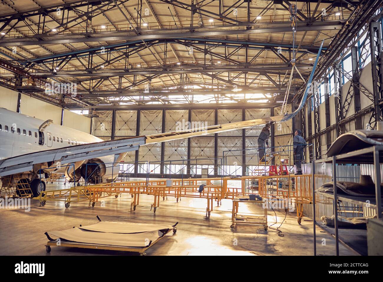 Wing and fuselage of the airplane in the aviation hangar Stock Photo ...