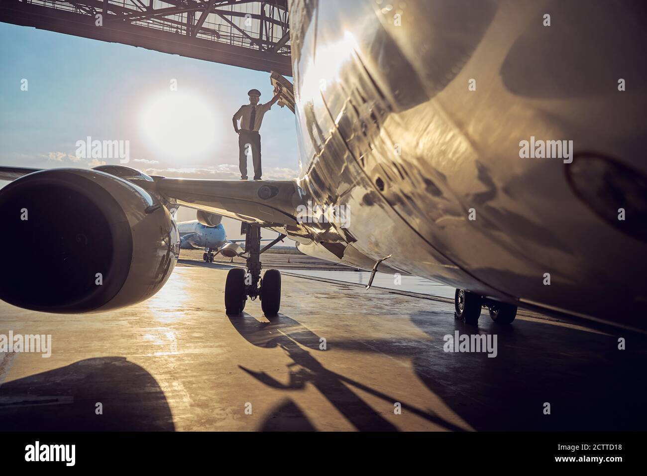 Beautiful image of aircraft with captain on the wing in the outdoors ...