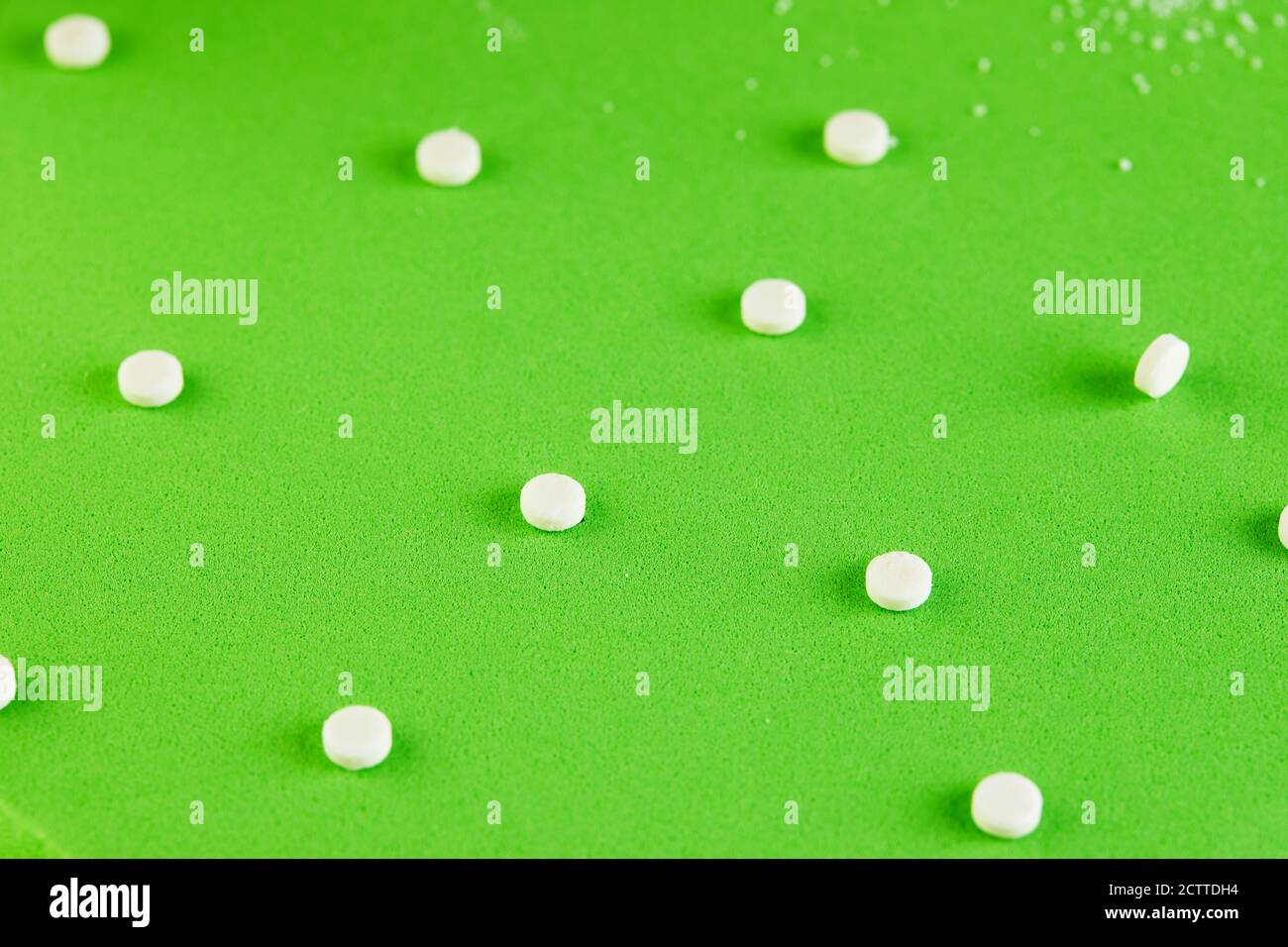 Sugar substitute pills and natural sweetener in powder on a green ...