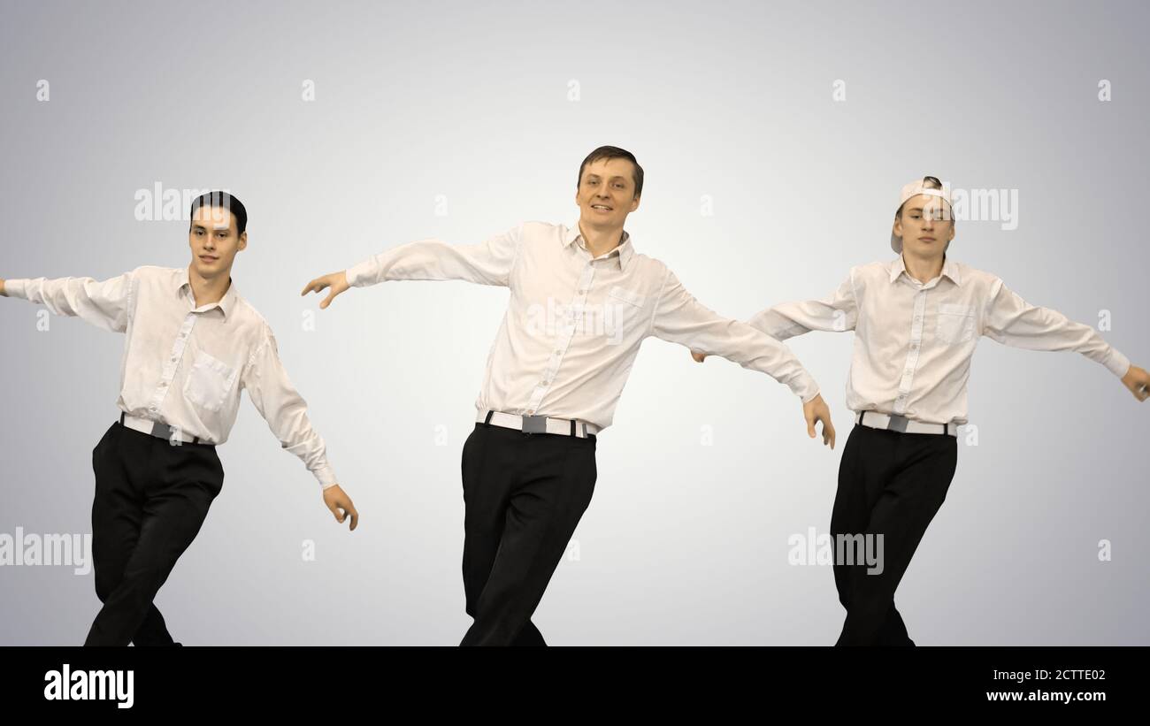 Three smiling guys in white shirts doing synch dance routine loo Stock ...