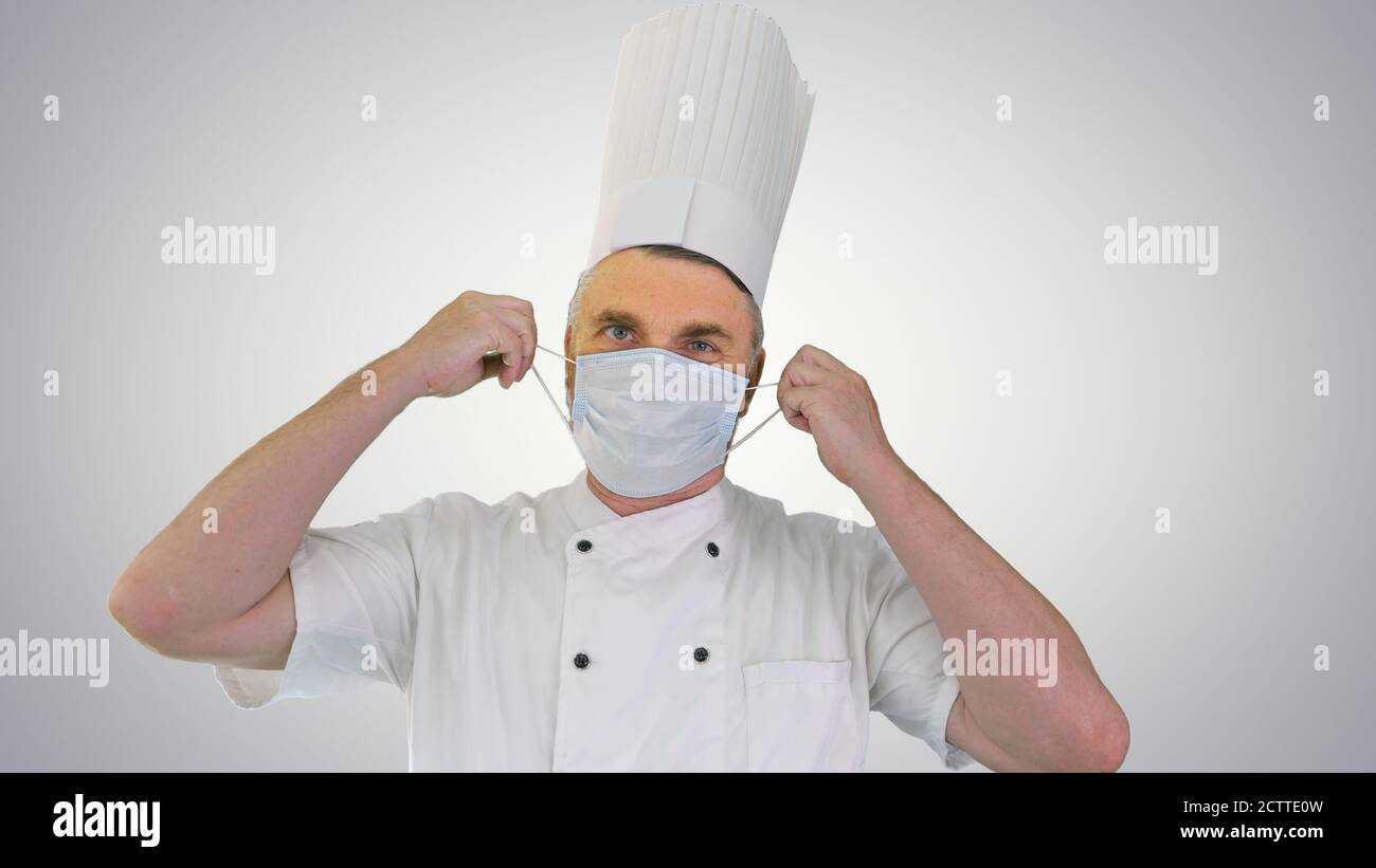 Male chef cook taking medical mask off and smiling to camera on Stock ...