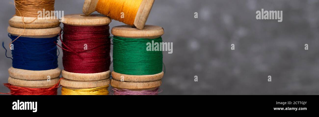 Different colorful cotton mill on grey background Stock Photo - Alamy