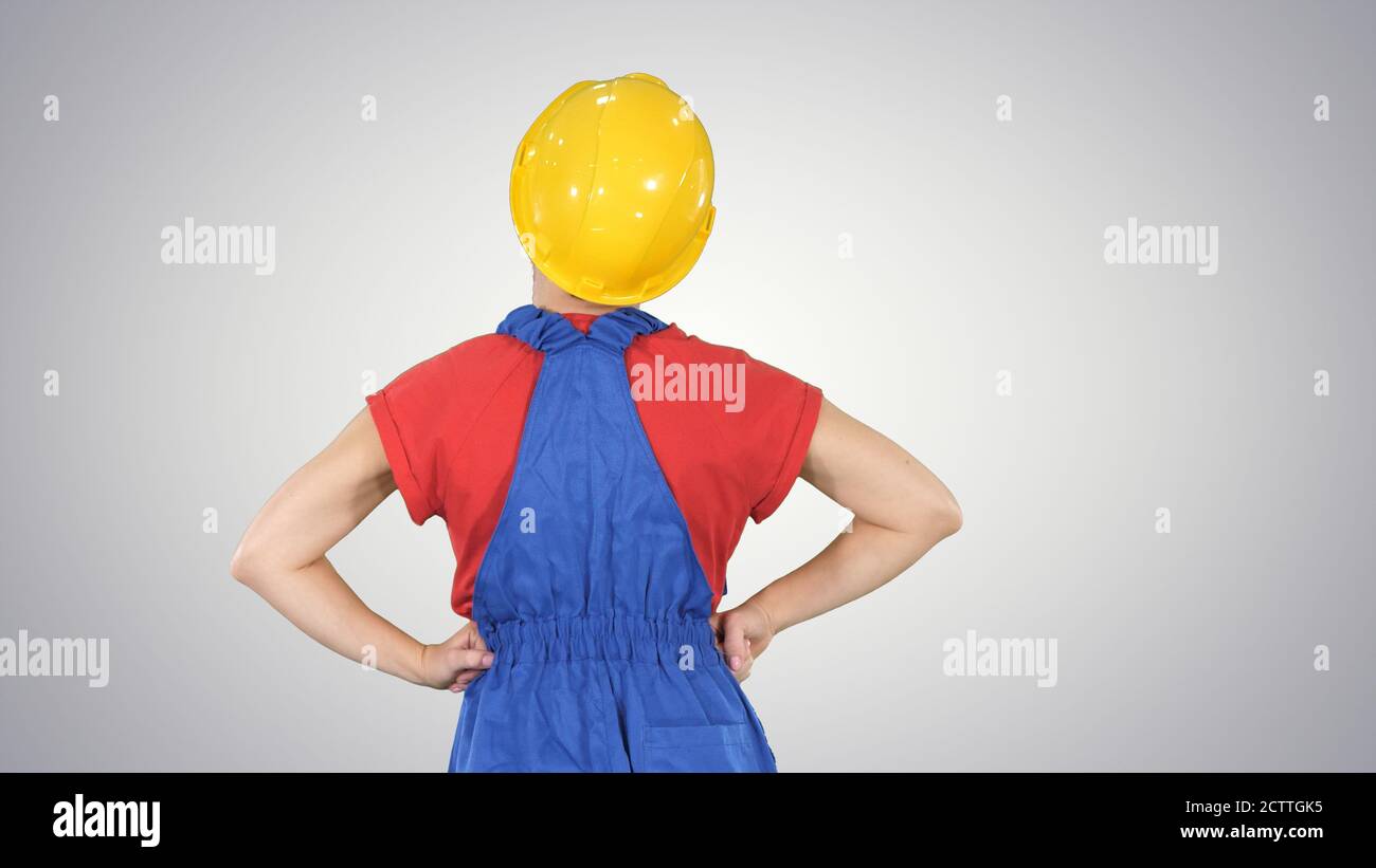 Female construction worker with hands on hips looking at somethi Stock ...