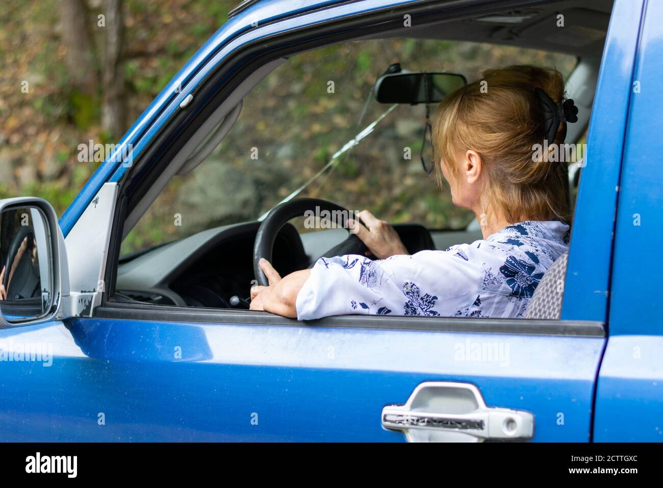 Senior lady drives the car in outdoor Stock Photo - Alamy