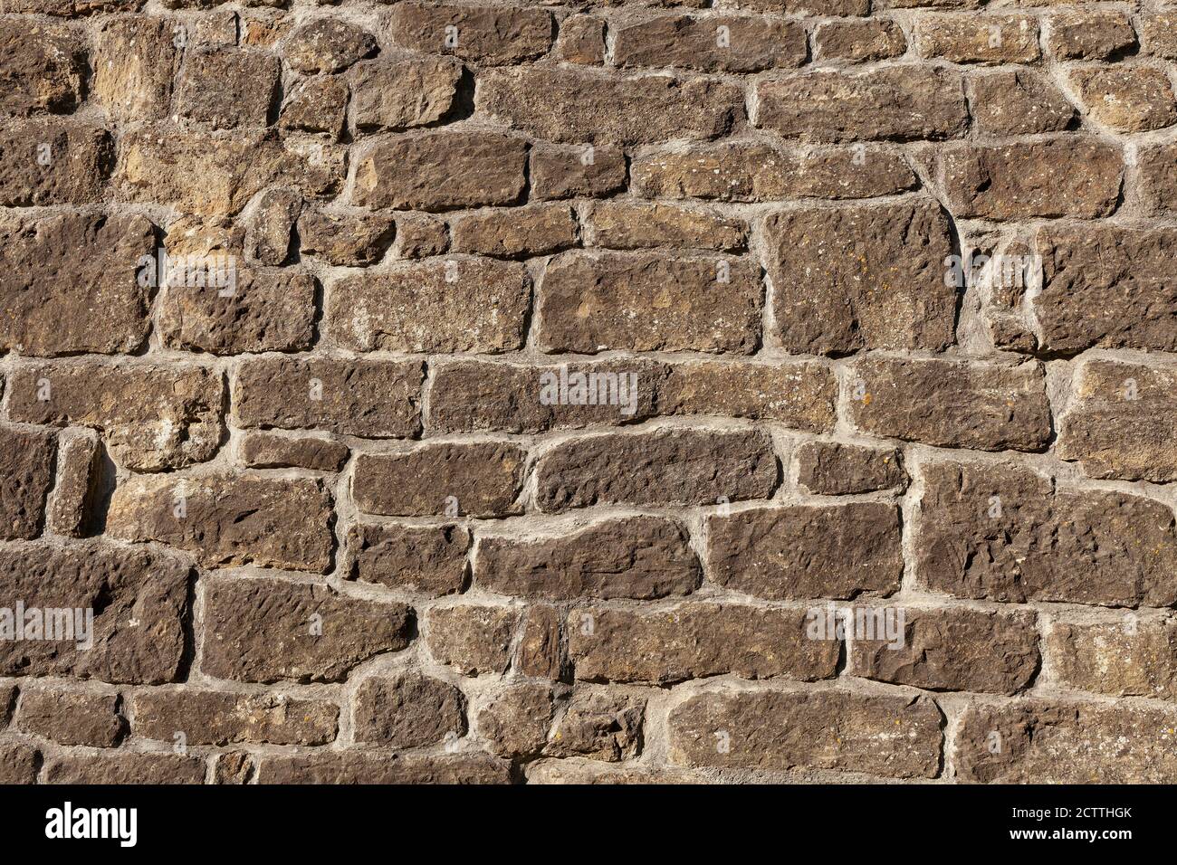 Brown stone wall, rough and textured Stock Photo - Alamy