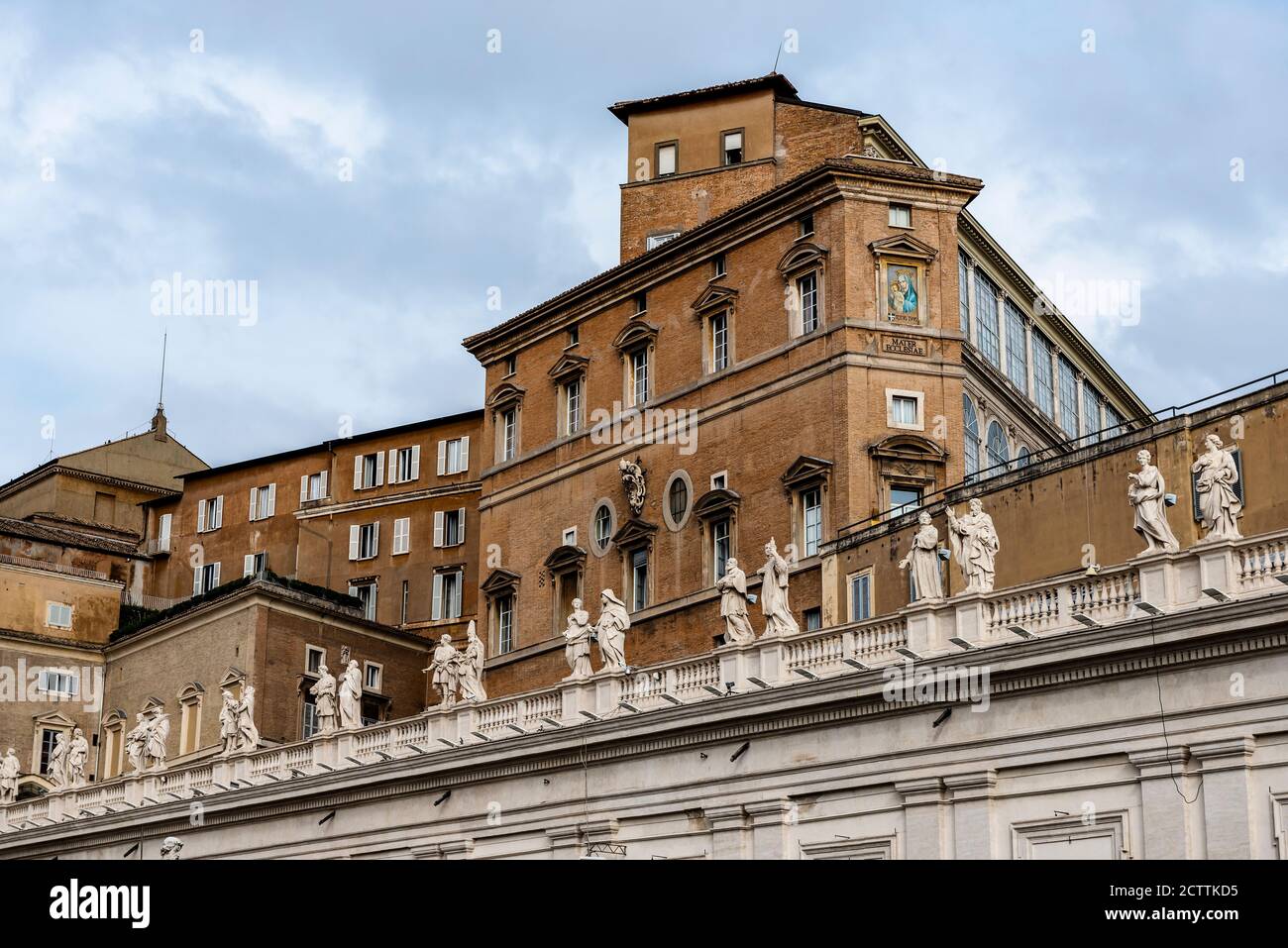 Wall with sculptures and different shapes of buildings in the Vatican ...