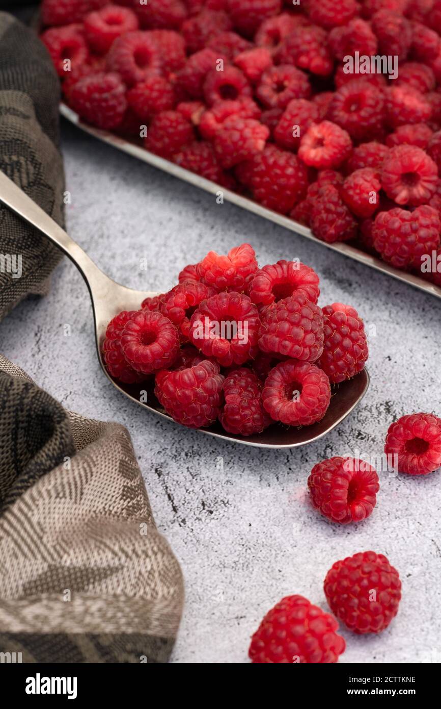 Fresh picked raspberries on grey background, healthy eating concept ...