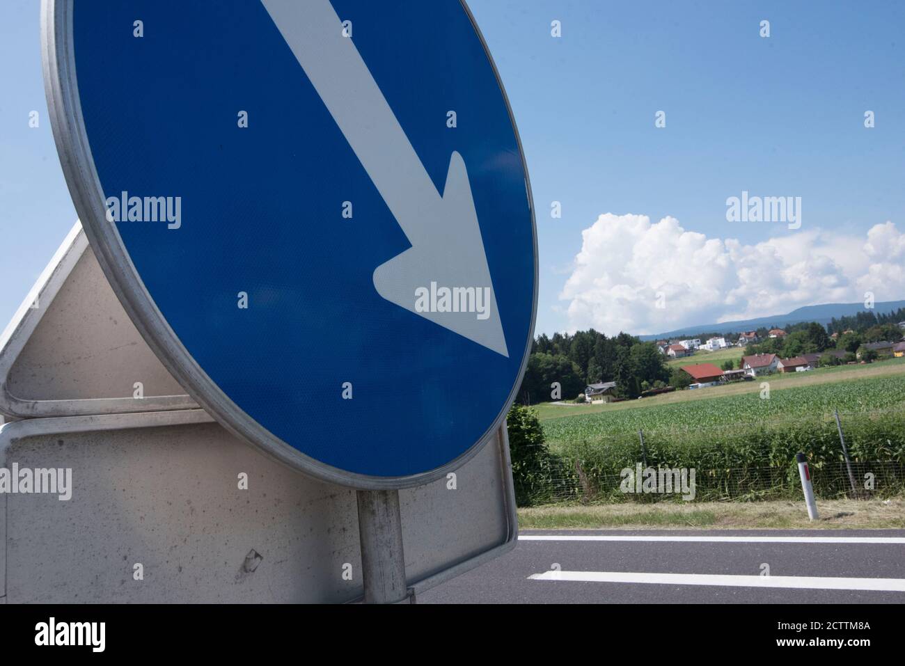 Direction sign with arrow showing the way in road traffic Stock Photo ...