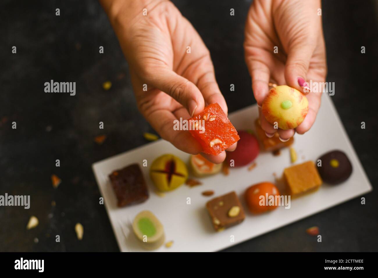 Indian sweets, mithai milk Peda and Halwa or Halva, woman holding ...