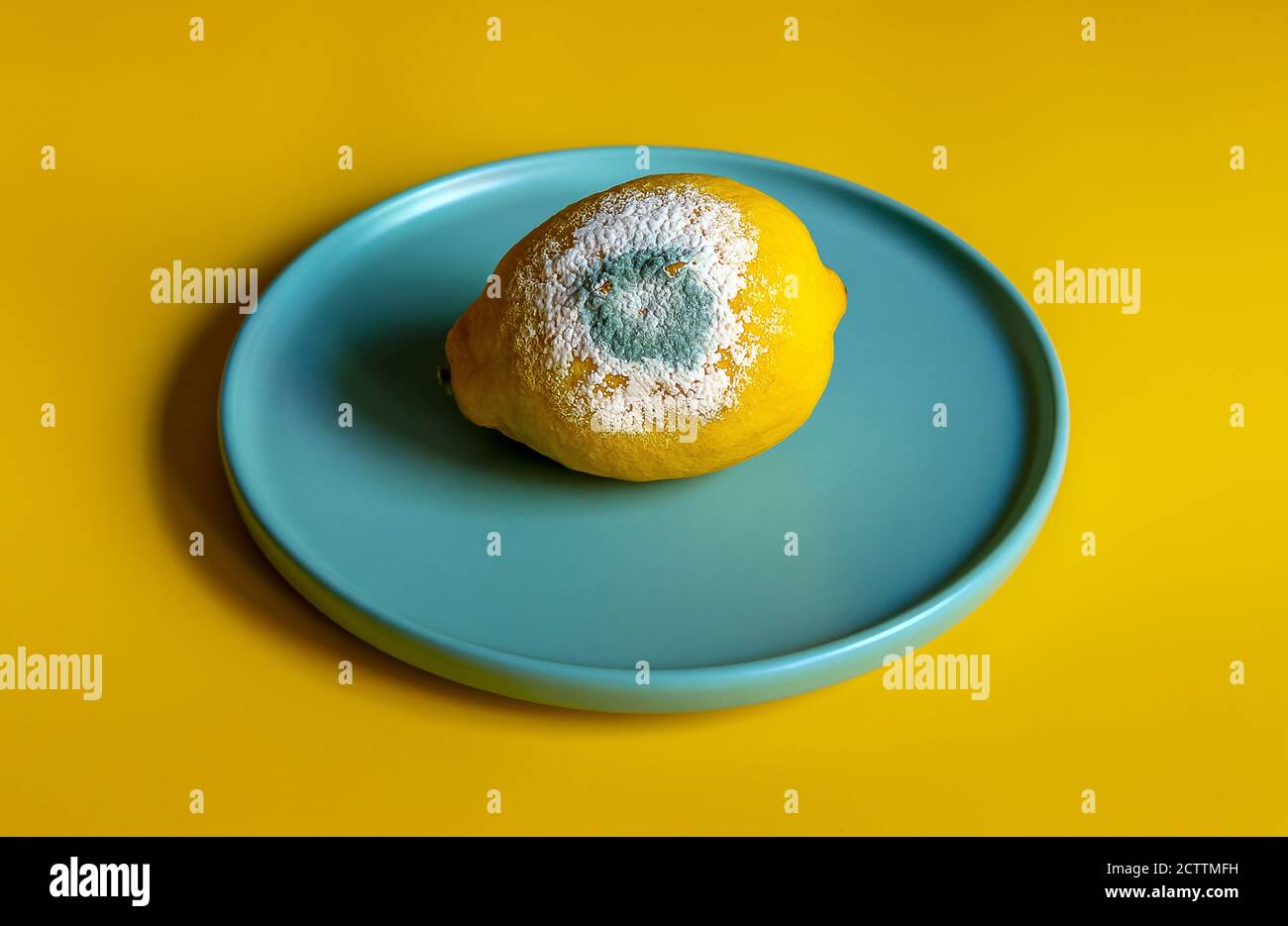 Yellow spoiled lemon with mold on a yellow background Stock Photo - Alamy