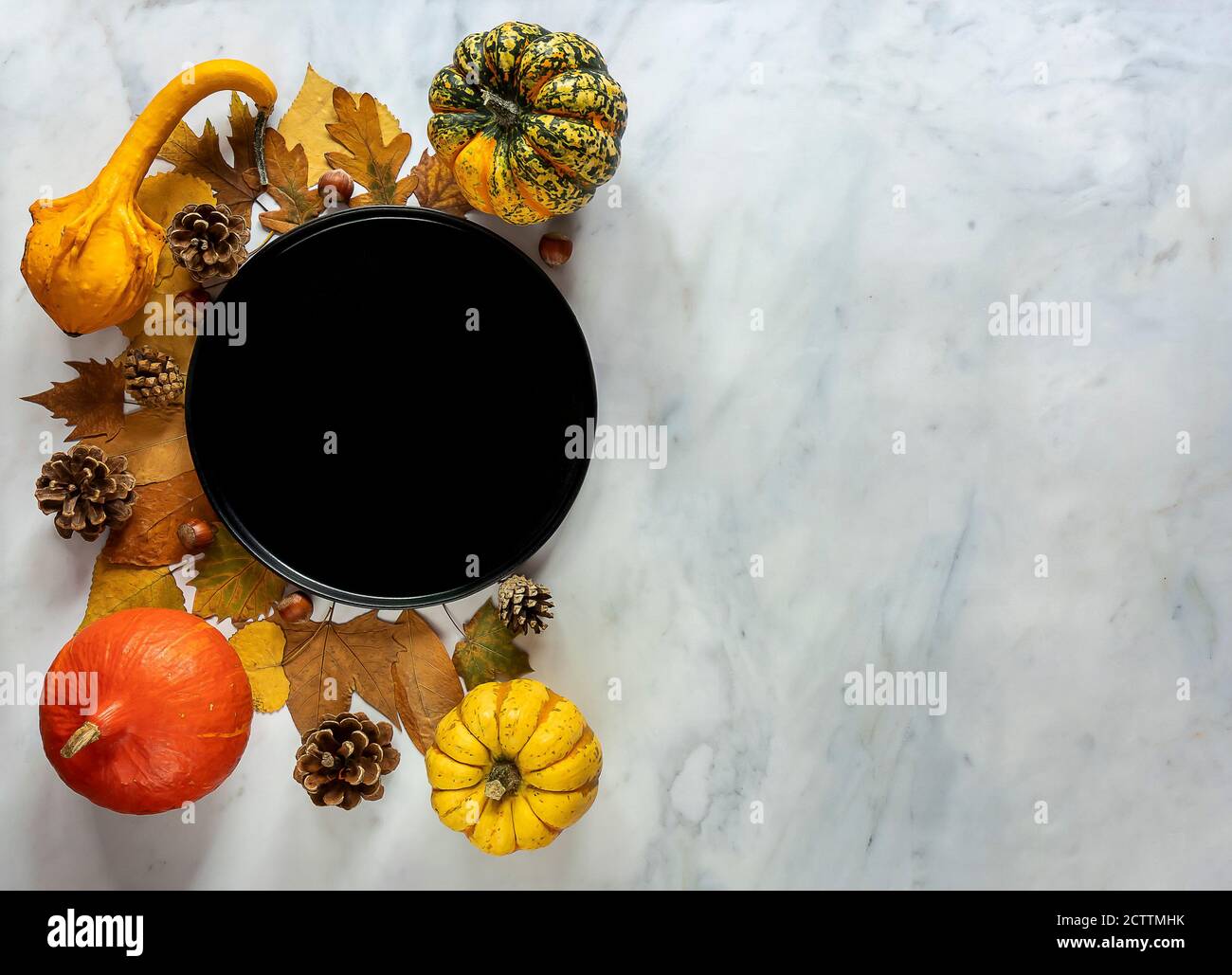 Autumn and Thanksgiving day table setting with fallen leaves, pumpkins ...