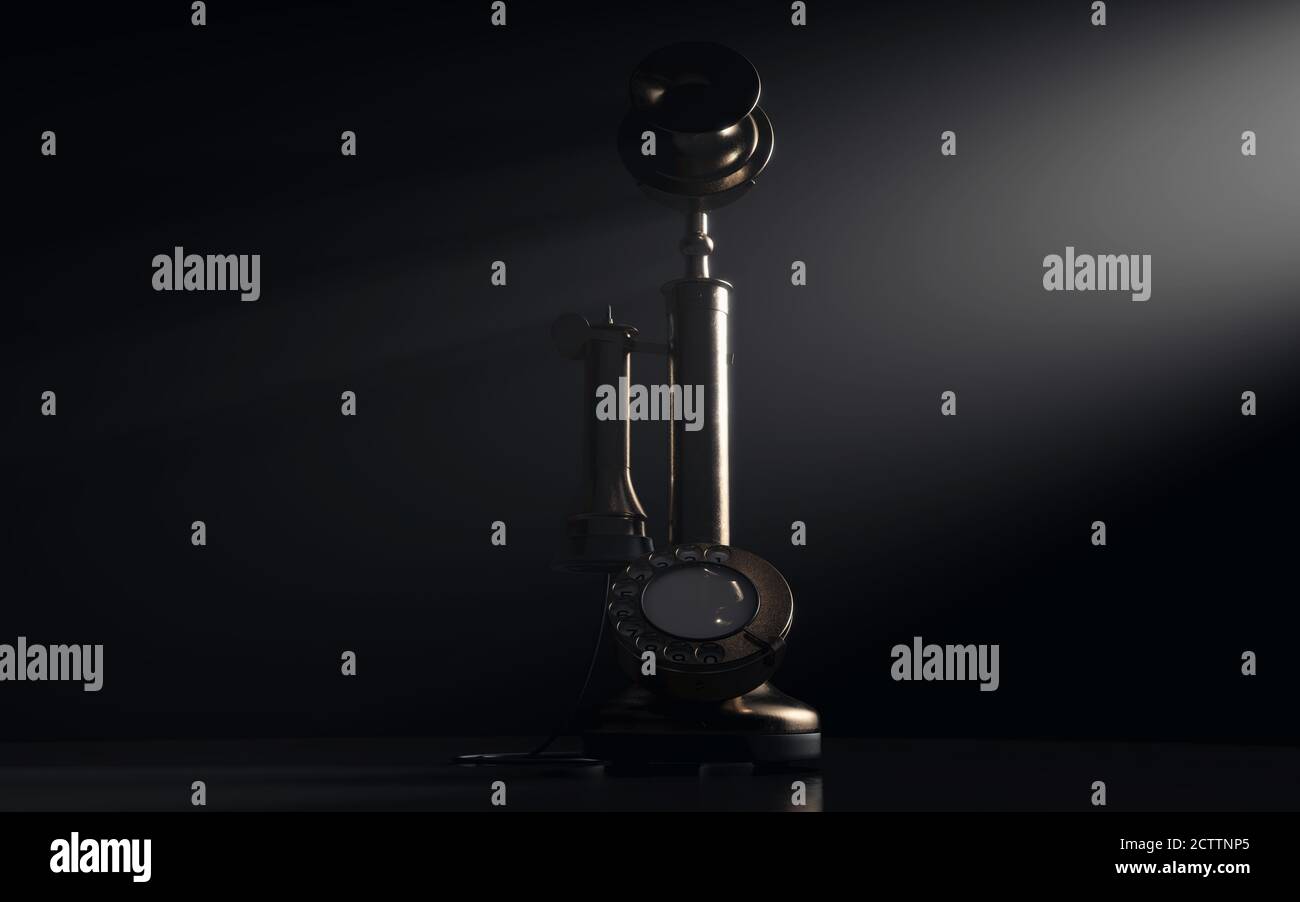 A vintage retro candlestick bell telephone made of brass on an a dark ...