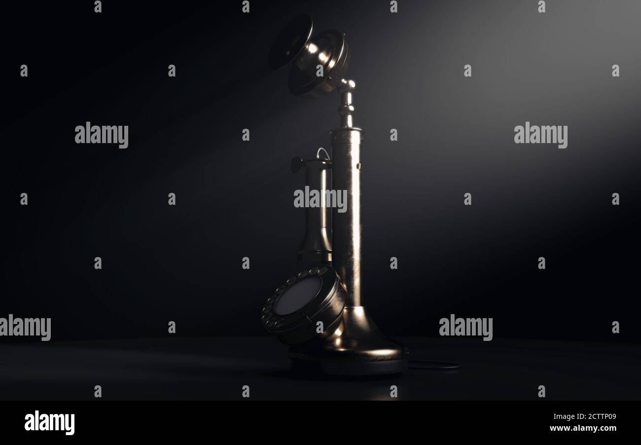 A vintage retro candlestick bell telephone made of brass on an a dark ...