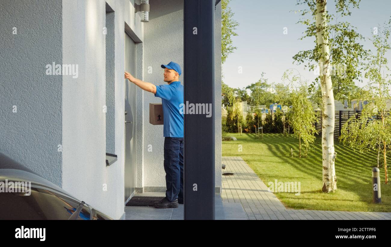 Delivery Man House and Delivers Cardboard Box Package to a Big ...