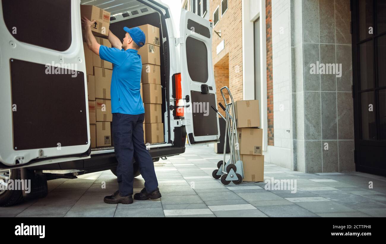 Delivery Man Uses Hand Truck Trolley Full of Cardboard Boxes and ...