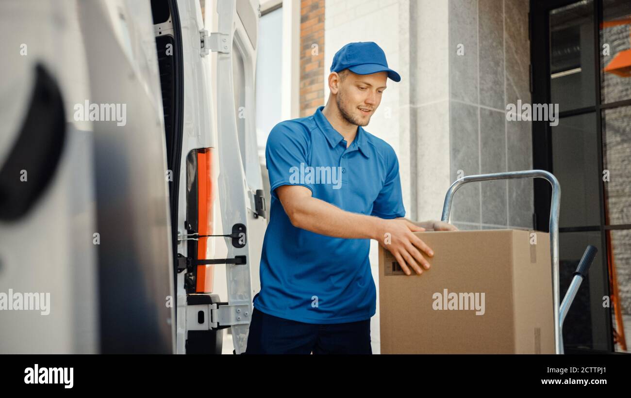 Delivery Man Uses Hand Truck Trolley Full of Cardboard Boxes and ...