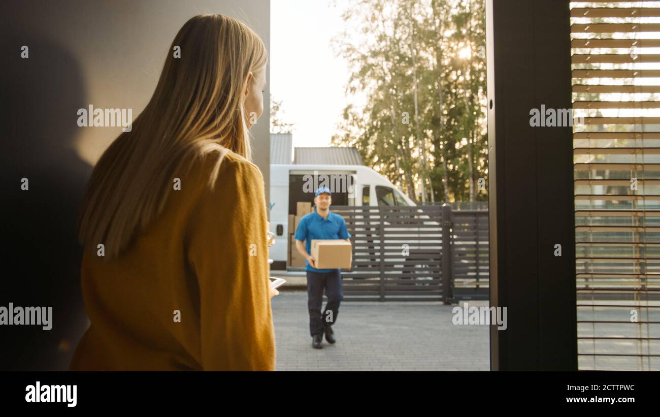 Delivery Man House and Delivers Cardboard Box Package to a Beautiful ...