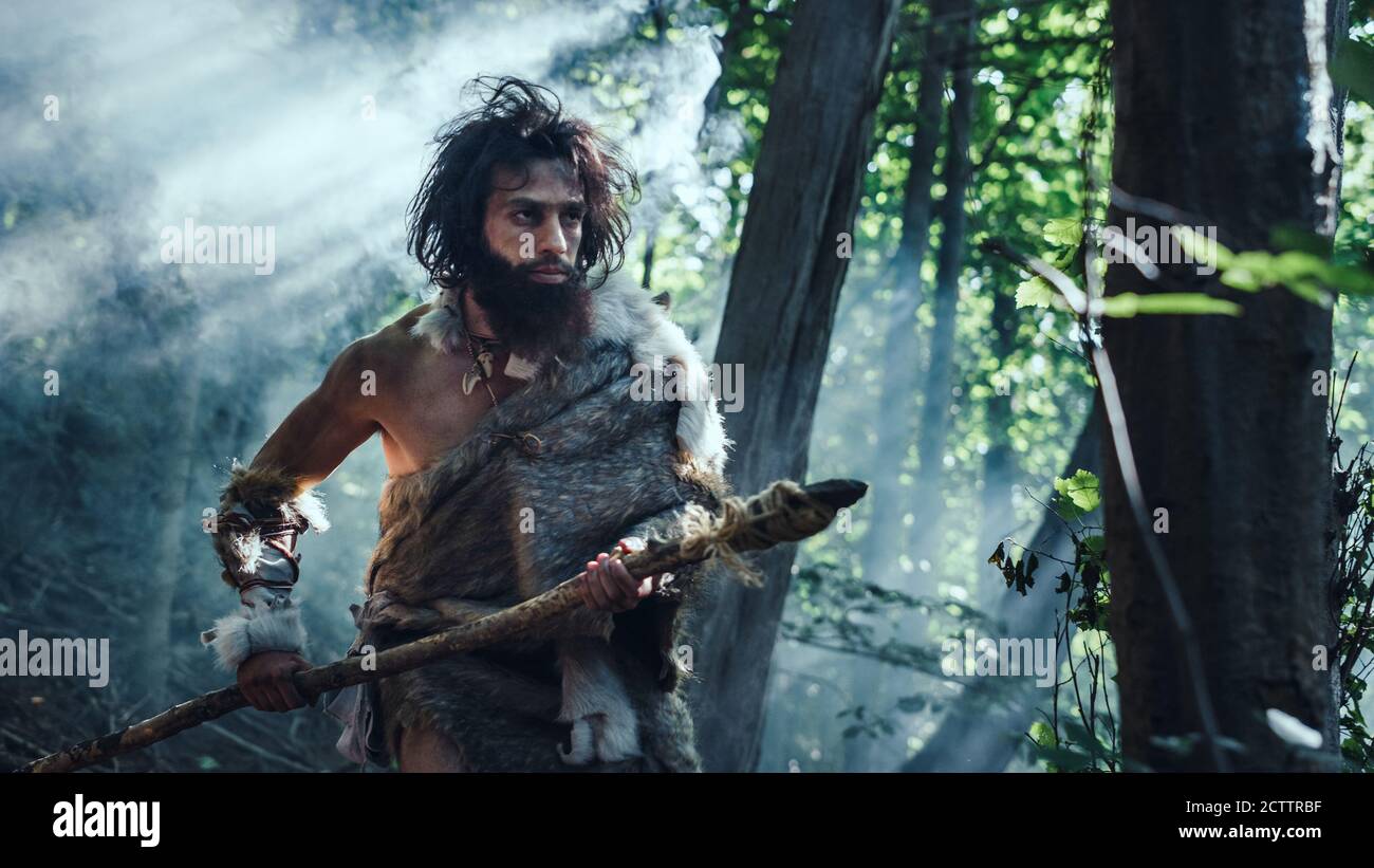 Portrait of Primeval Caveman Wearing Animal Skin and Fur Hunting with a ...