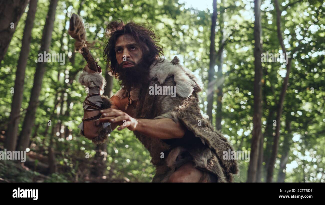 Portrait of Primeval Caveman Wearing Animal Skin and Fur Hunting with a ...