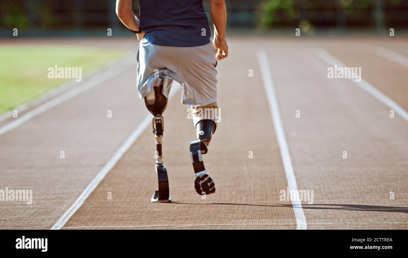 Athletic Disabled Fit Man with Prosthetic Running Blades is Training on ...