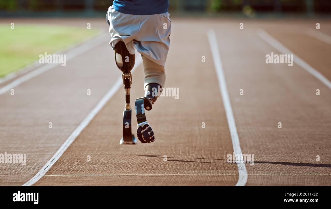 Athletic Disabled Fit Man with Prosthetic Running Blades is Training on ...