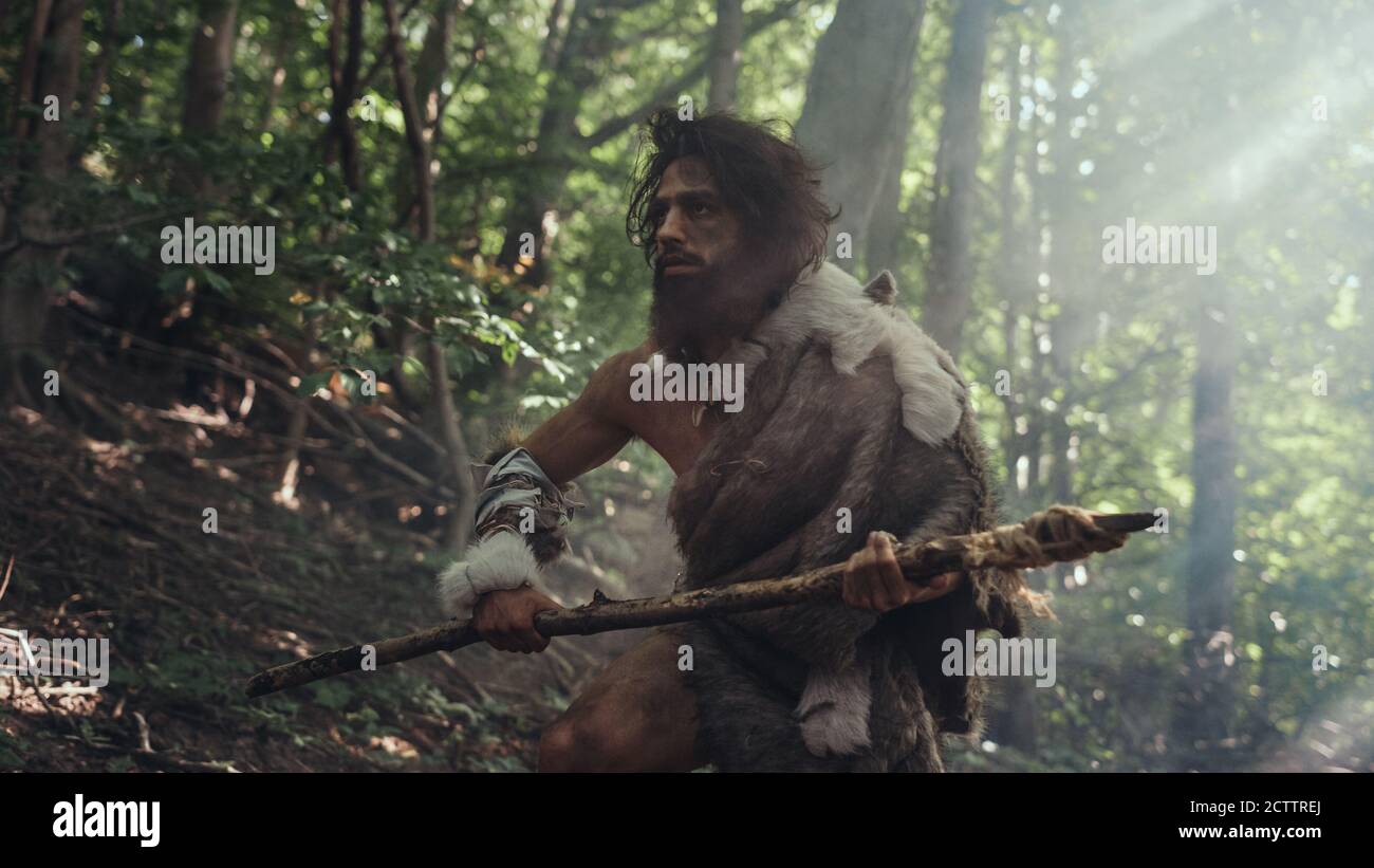 Portrait of Primeval Caveman Wearing Animal Skin and Fur Hunting with a ...