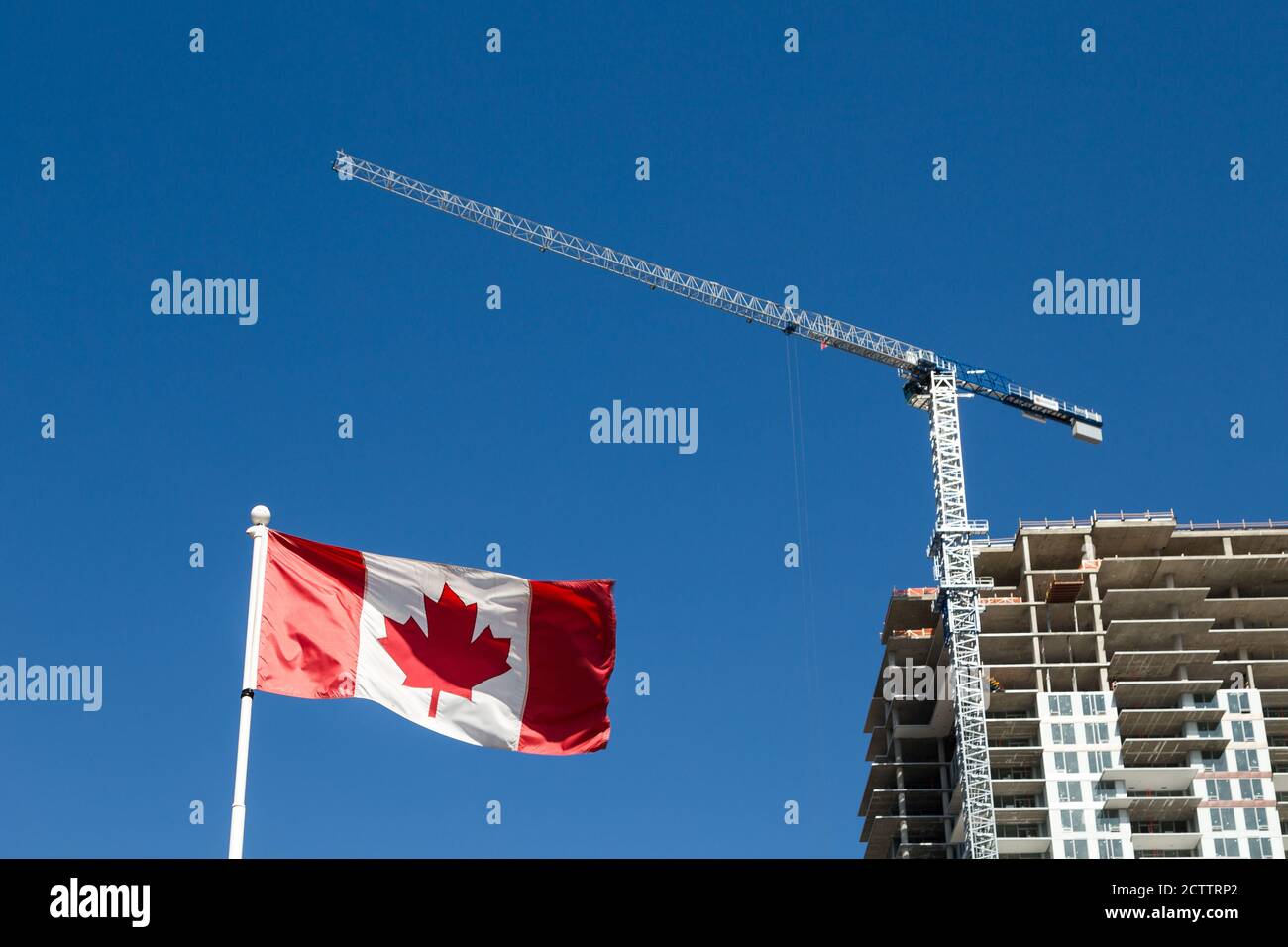Canadian flag with apartment building under construction in the ...