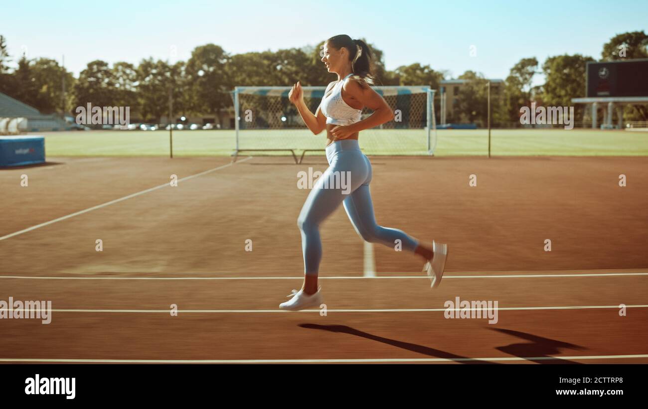 Beautiful Fitness Woman in Light Blue Athletic Top and Leggings Jogging ...